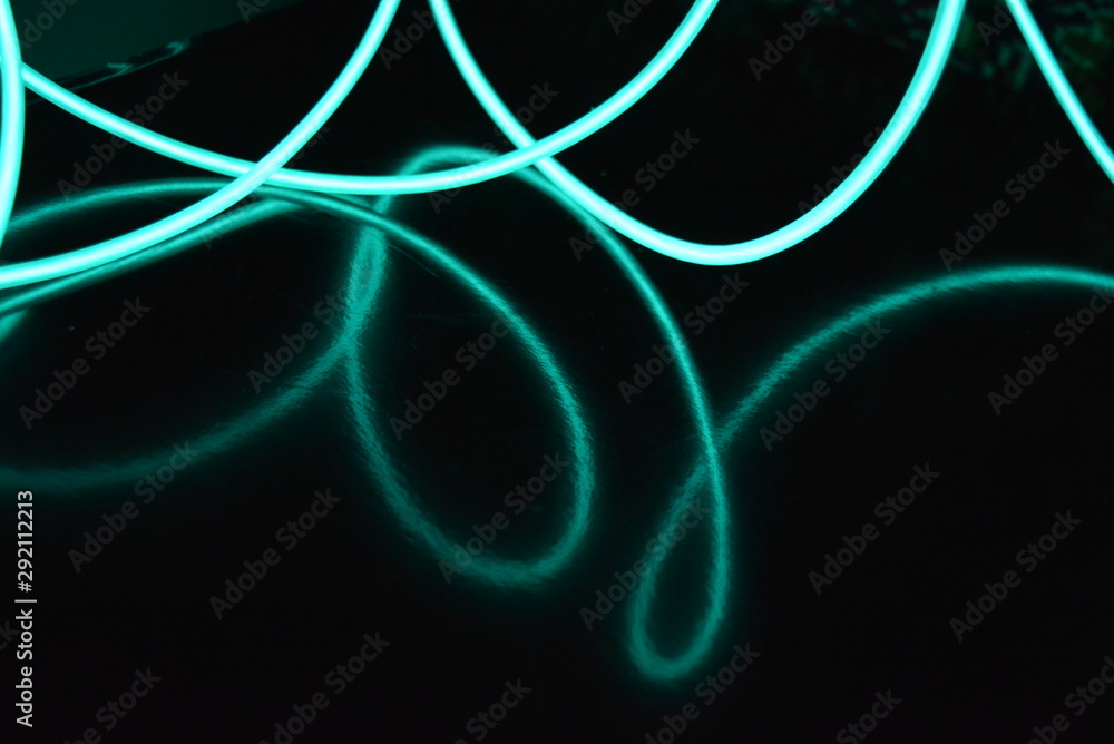 Unusual bright wires made of turquoise-colored material glowing at ...