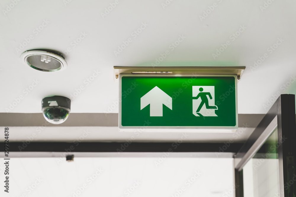 fire exit sign on ceiling with opened door for emergency case Stock ...