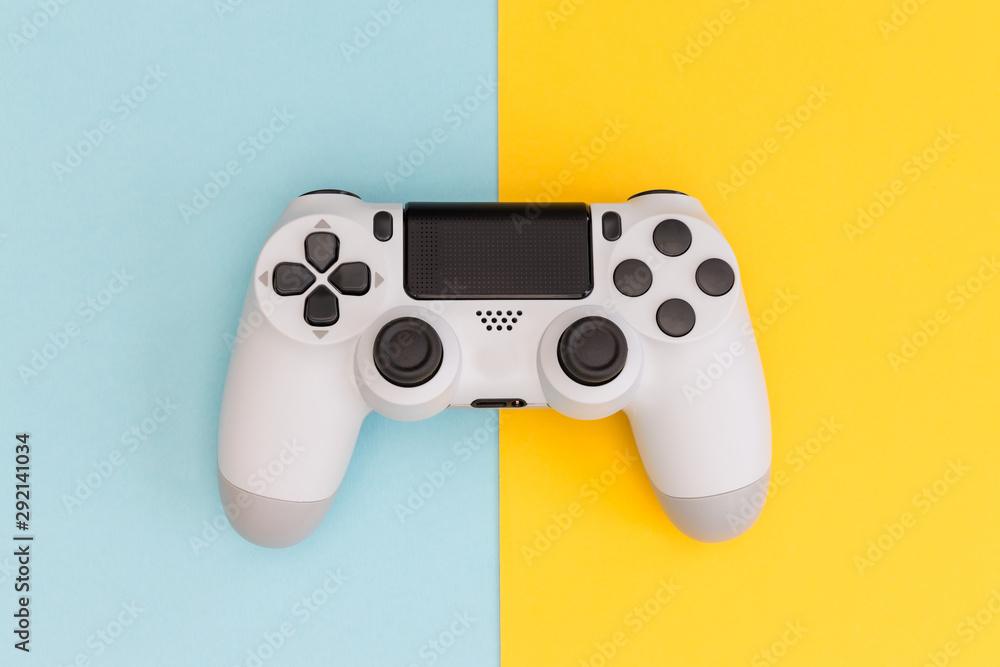 Video games white gaming controller isolated on yellow blue color ...