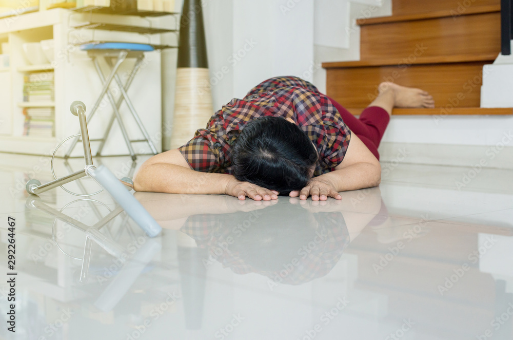 Senior asian woman suffering with faint lying on floor after falling ...