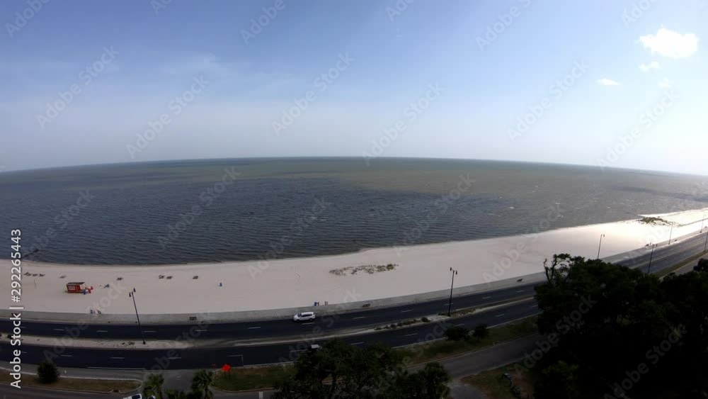 time-lapse, mostly blue skies, showing ocean, beach, main road with ...