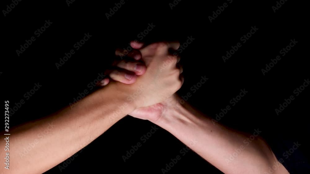 Slow motion shot of two hands coming together in a handshake in the ...