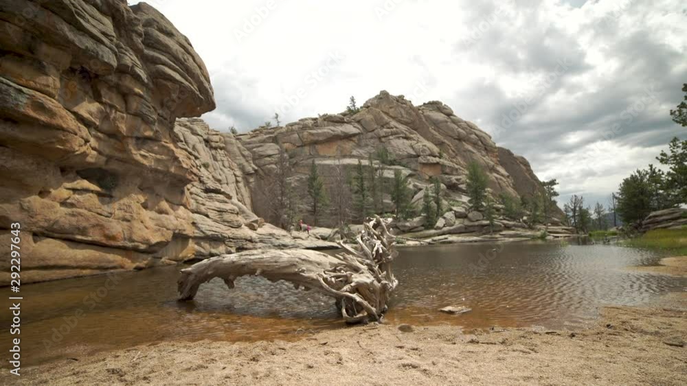 Tilt down slider shot of unique rock formations and driftwood at Gem ...