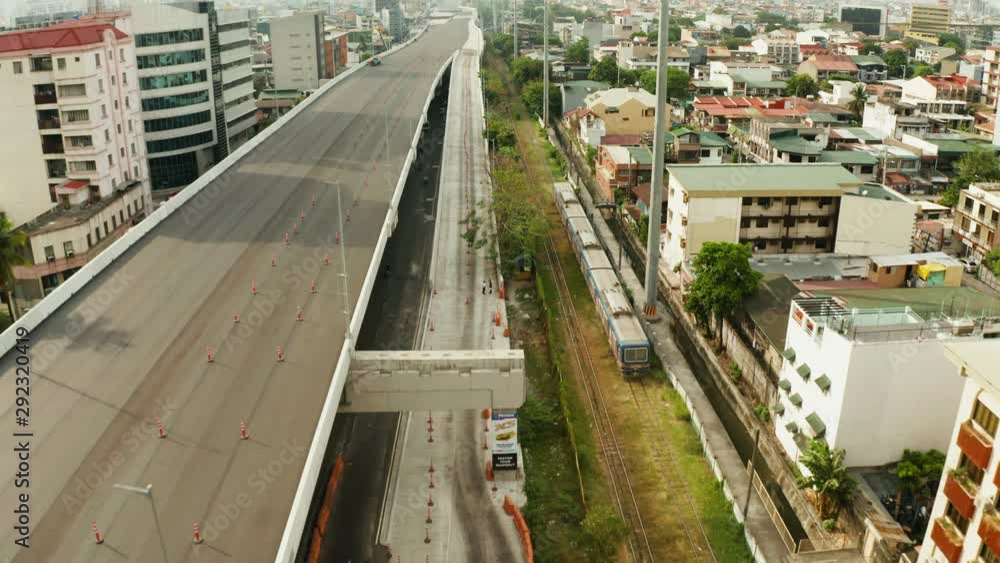 Highway and train on a railway in the city of Manila, Philippines, top ...