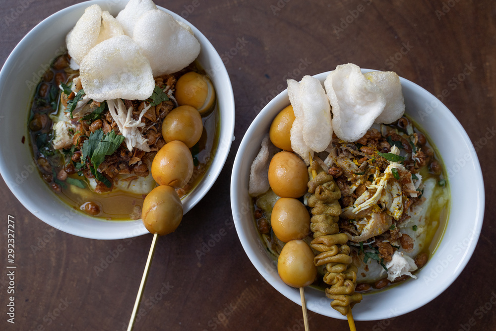 indonesian food of bubur ayam serve with crackers,sate telur puyuh,and ...