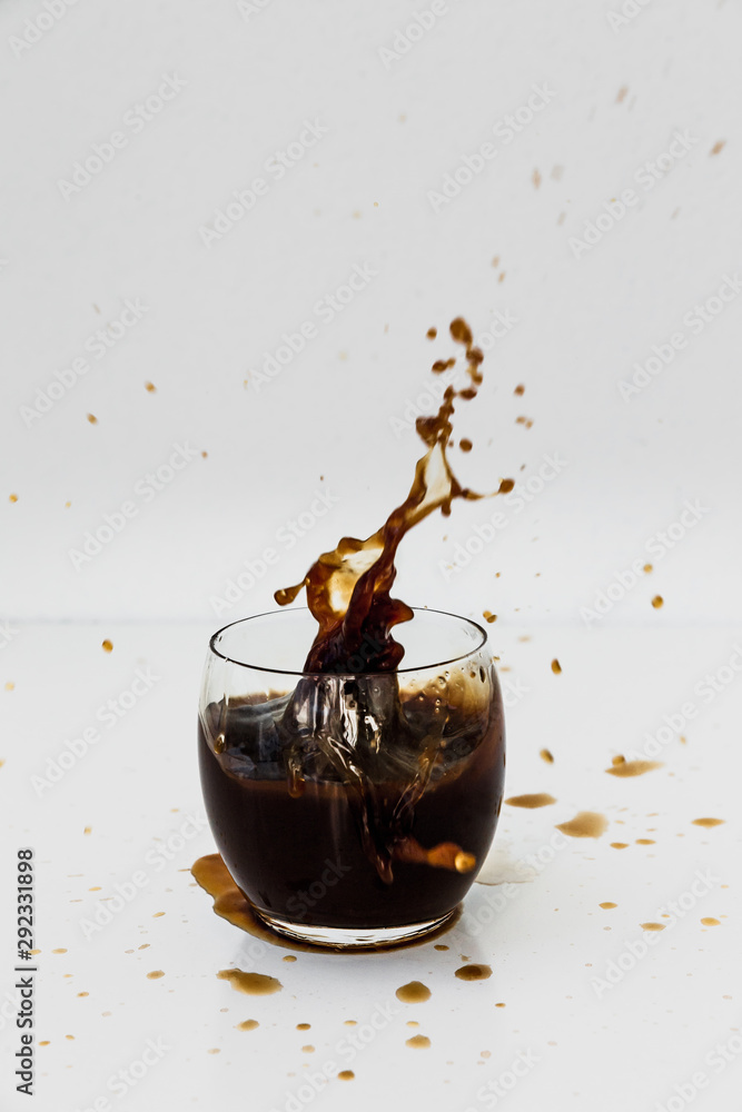 Black coffee splash, glass, white background, coffee drops, vertical ...