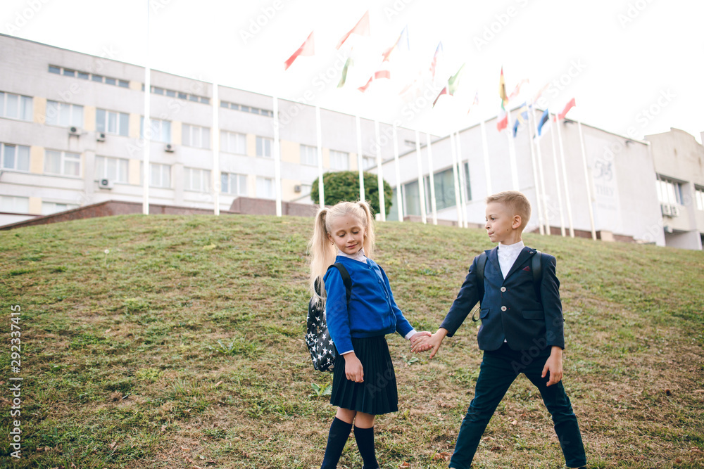 Young students, boy and girl, going to school. Two school kids with ...