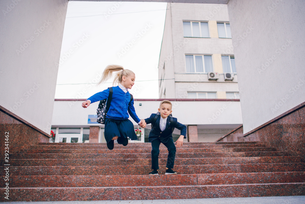 Young students, boy and girl, going to school. Two school kids with ...