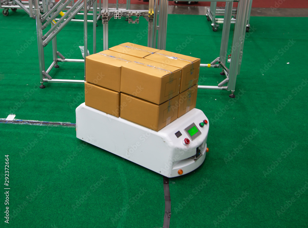 Industry shuttle robot carry carton in modern warehouse factory ...