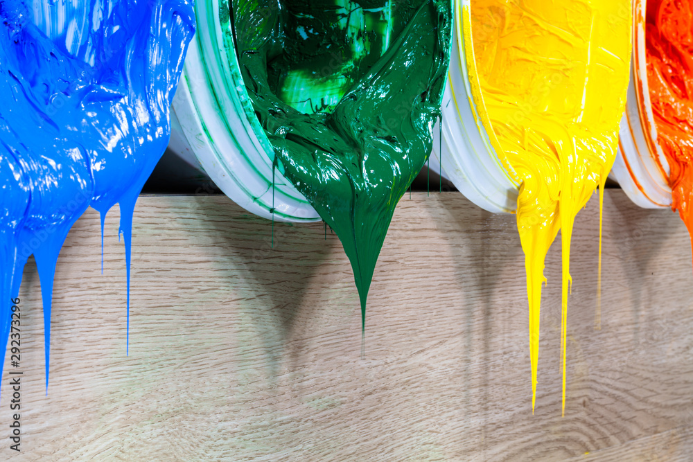 blue green yellow and orange colors of Plastisol ink in white barrel ...