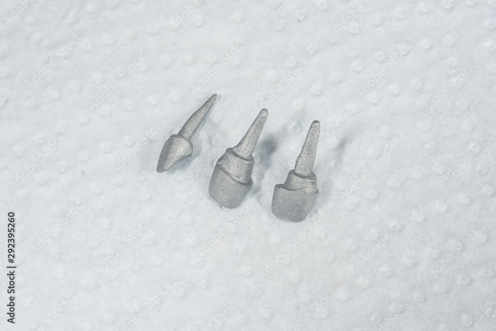 metal cast pin of a human tooth on a gypsum model close-up in a dental ...