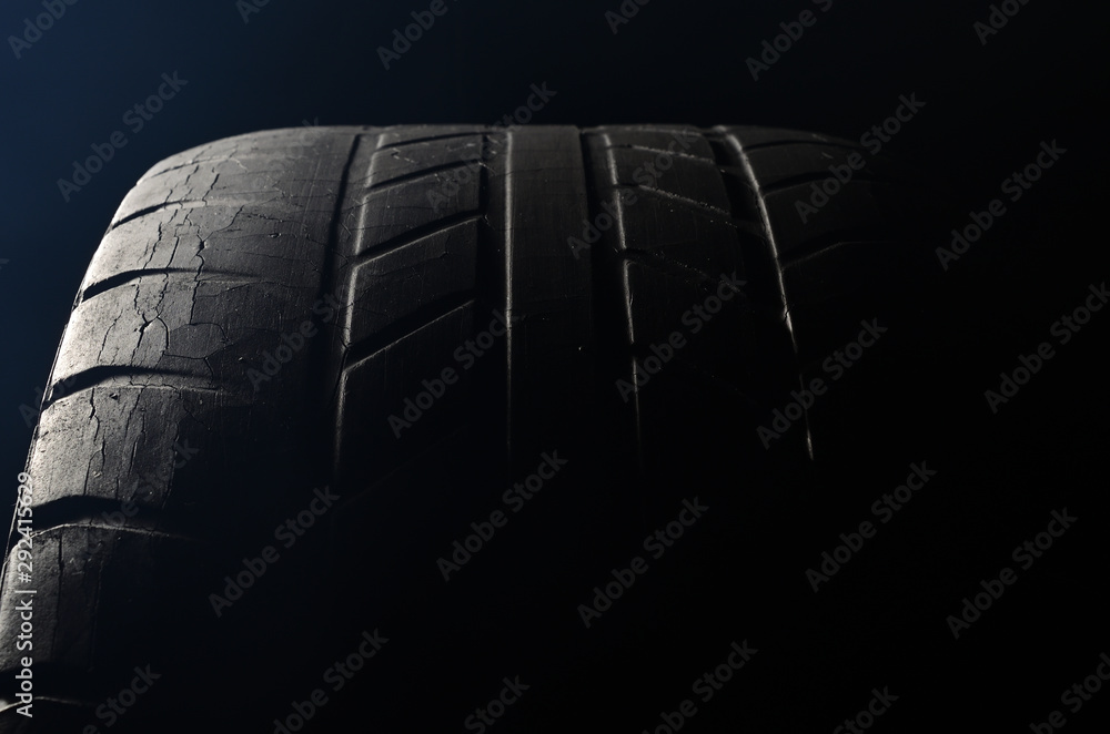 Old damaged, worn black tire tread, large cracks in the car wheel, tire ...