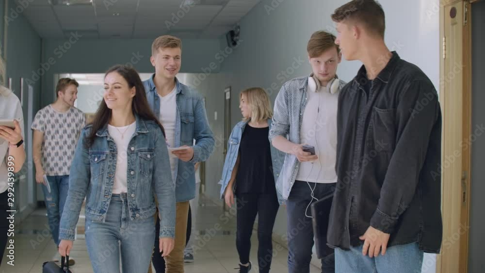 School break in the hallway a lot of students are walking and talking ...