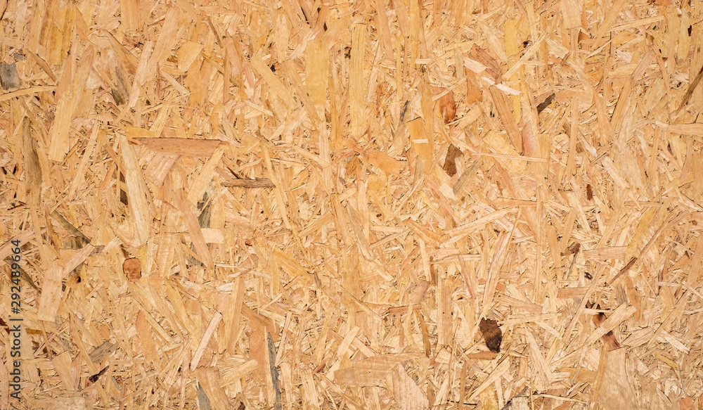 OSB boards are made of brown wood chips sanded into a wooden background ...