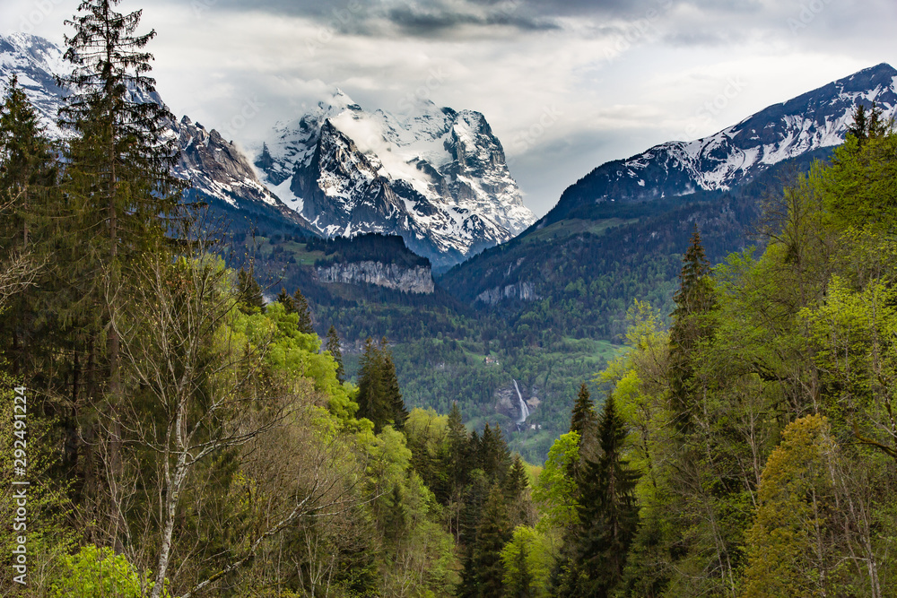 Swiss Alpine scenery of valleys, forests, waterfalls and snow covered ...