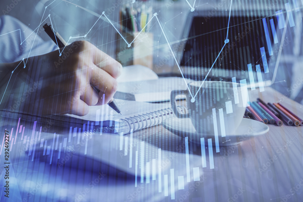 Financial chart drawn over hands taking notes background. Concept of ...