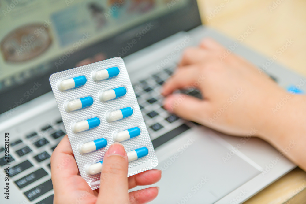 Pharmacist using the computer laptop in chemist shop or pharmacy drug ...