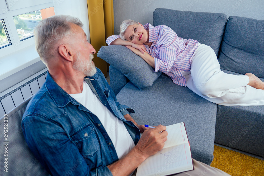 beautiful short haired goog-looking woman lying on the couch,old man ...