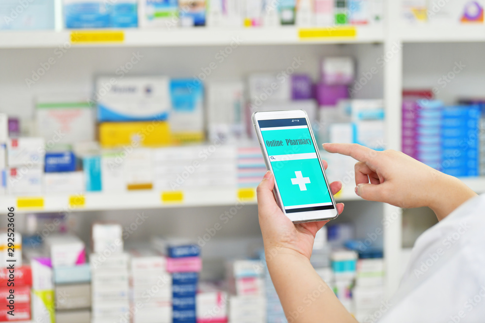 Pharmacist using mobile smart phone for search bar on display in ...