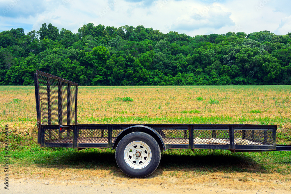 Trailer for harvest hay fields parking in front of the green farm on ...