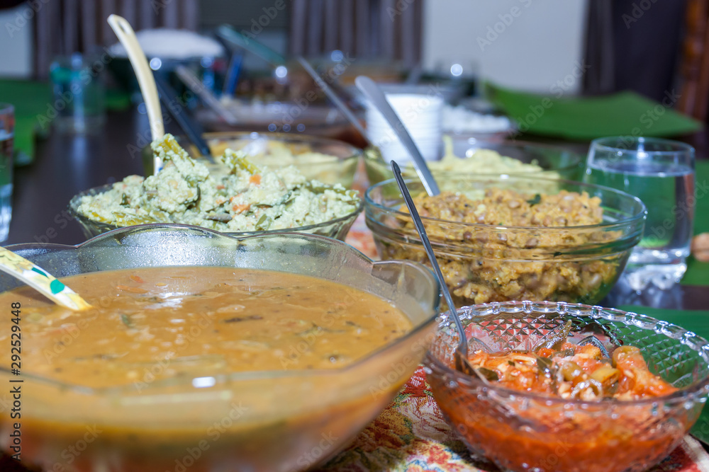 Dining table with Kerala vegetable curries in dishes served during Onam ...