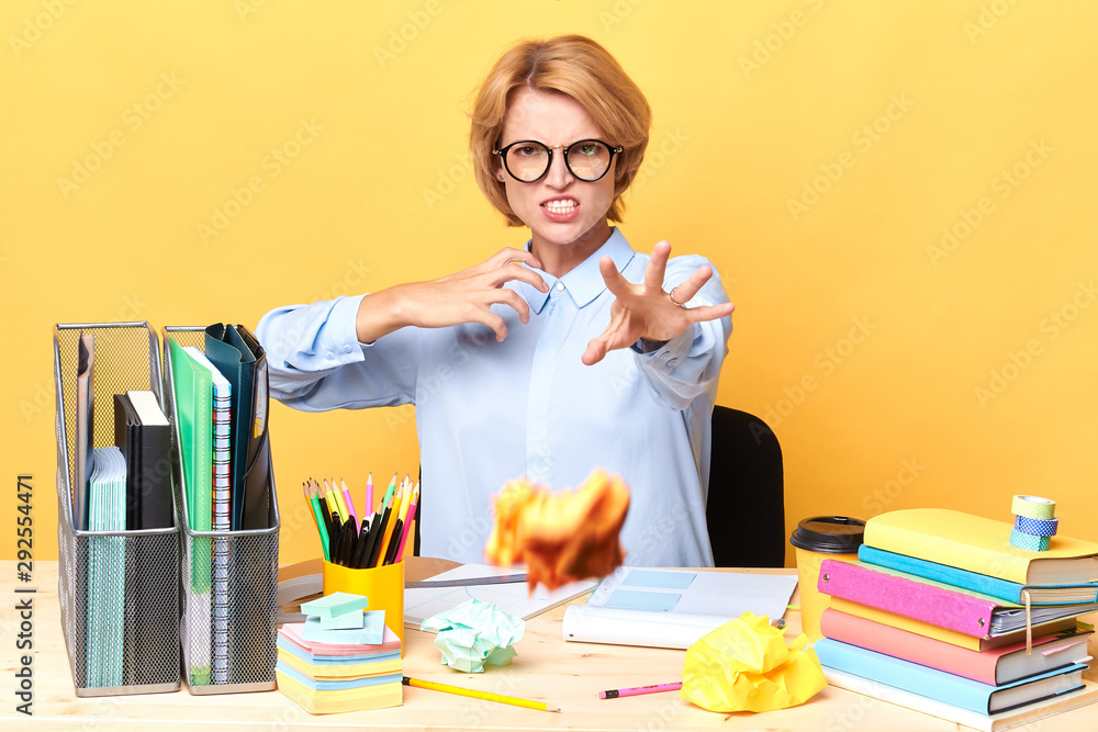 angry unhappy secretary throwing paper to the camera, woman is being ...
