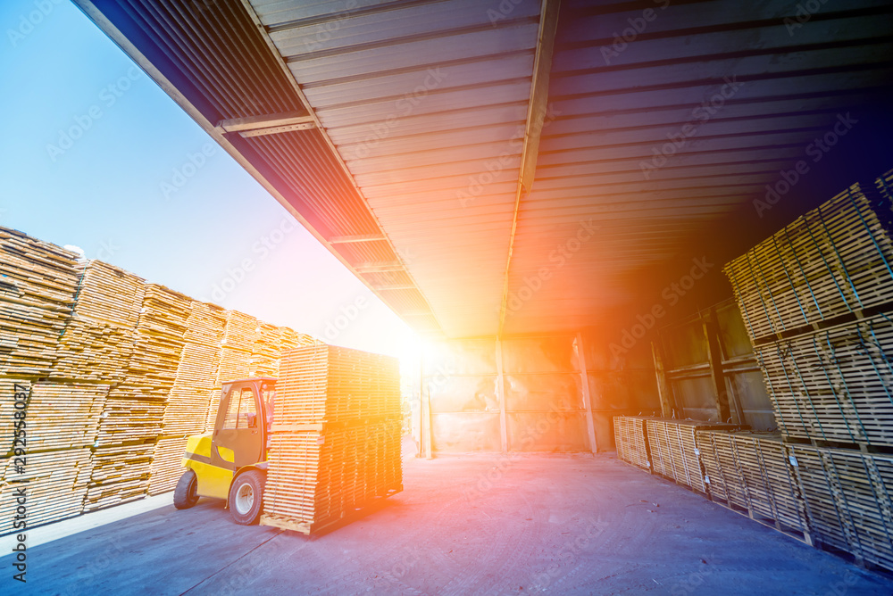 Forklift loader load lumber into a dry kiln. Wood drying in containers ...