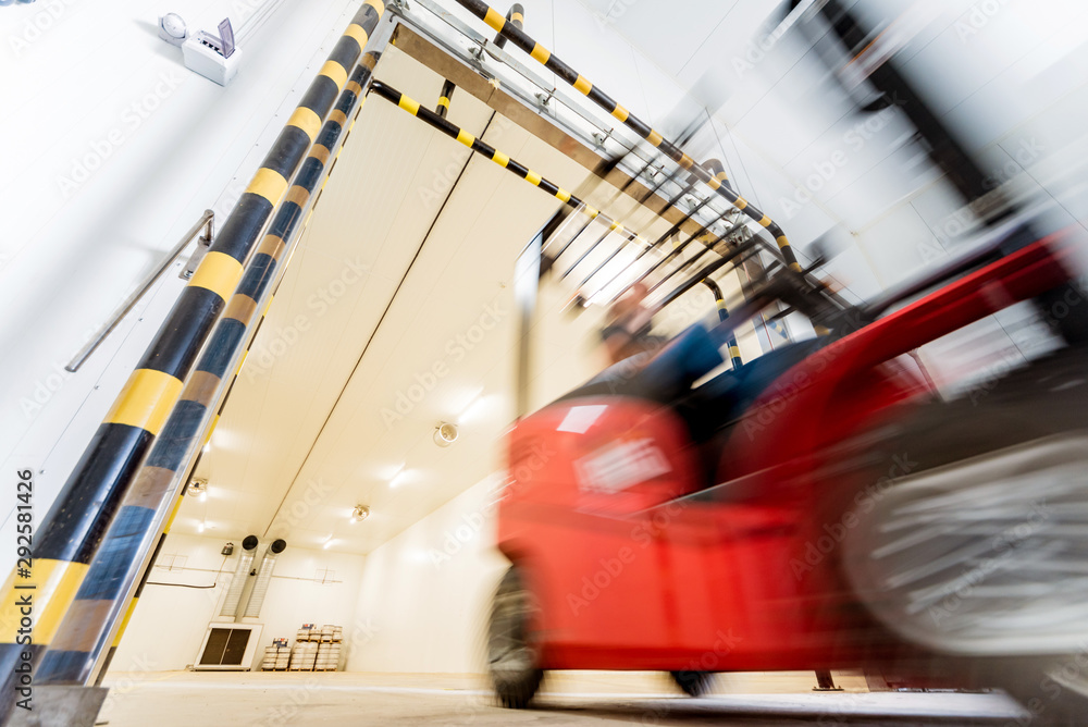 Forklift in a large industrial freezer warehouse. Empty warehouse for ...
