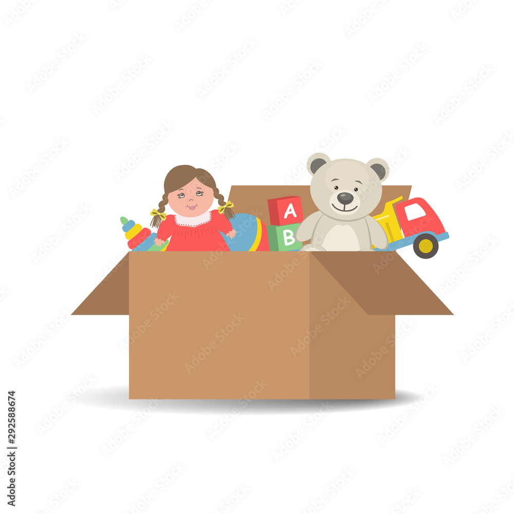 Children's toys in a cardboard box. There is a doll, a teddy bear, a ...