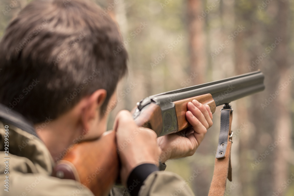 The hunter takes aim and is ready to shoot from a double barreled ...