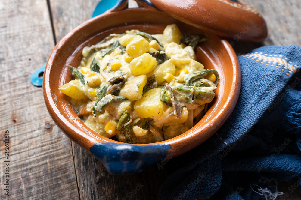 Mexican poblano rajas with potatoes and sour cream in clay cazuela ...