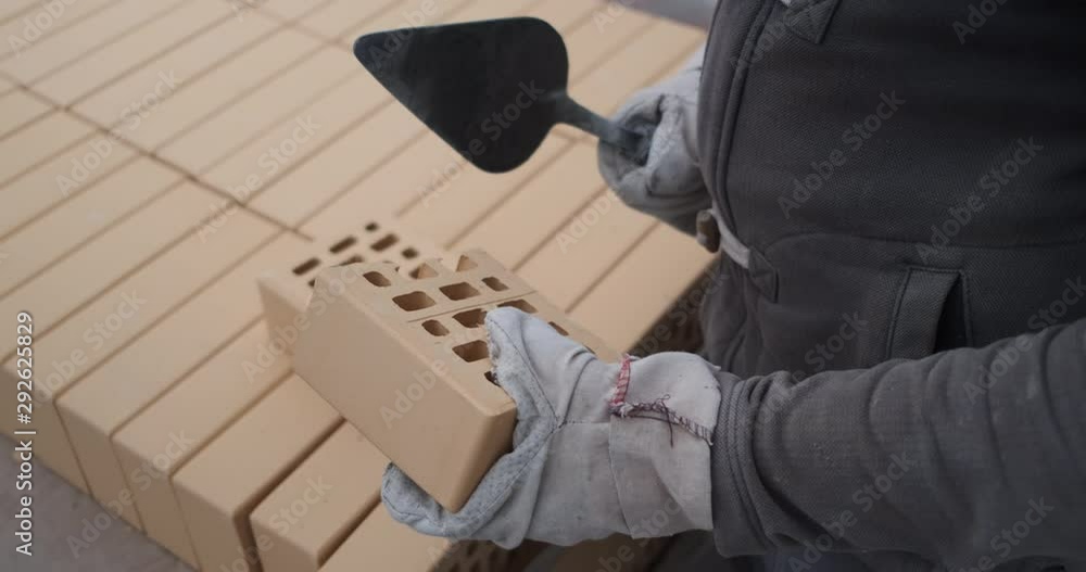 Close-up hands of builder with brick, one blow brick is broken into two parts Stock Video ...