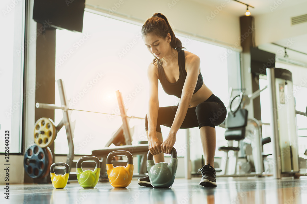Woman exercise workout at gym fitness training sport with kettlebells ...