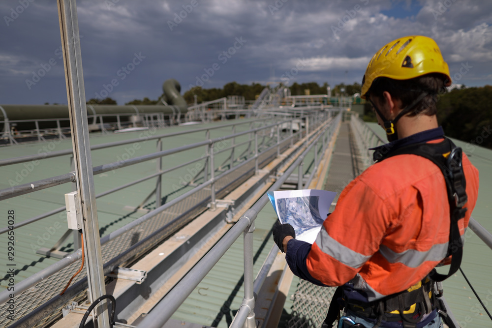 Construction civil engineer planer wearing safety helmet harness ...