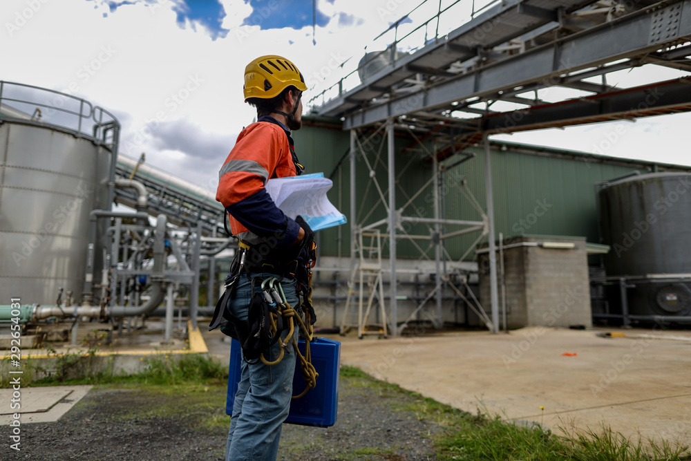 Construction civil engineer planer wearing safety helmet harness ...