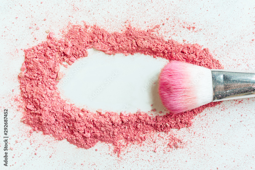Smear of crushed pink blush on as sample of cosmetics product and brush ...