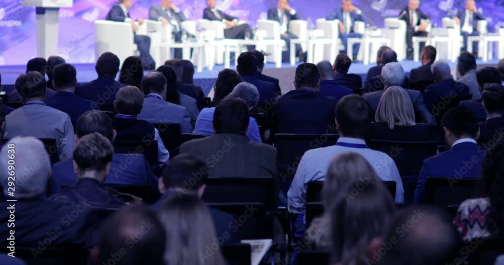 Politicians or scientists speak from the stage, people in audience ...