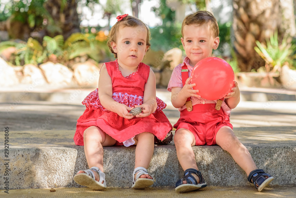 twin brother giving his sister a kiss on the cheek. Children playing in ...