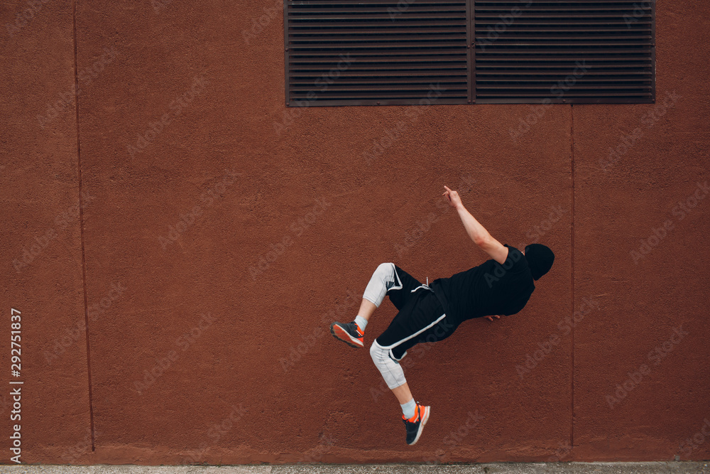 Parkour young man making acrobatic trick and flip jumping high Stock ...