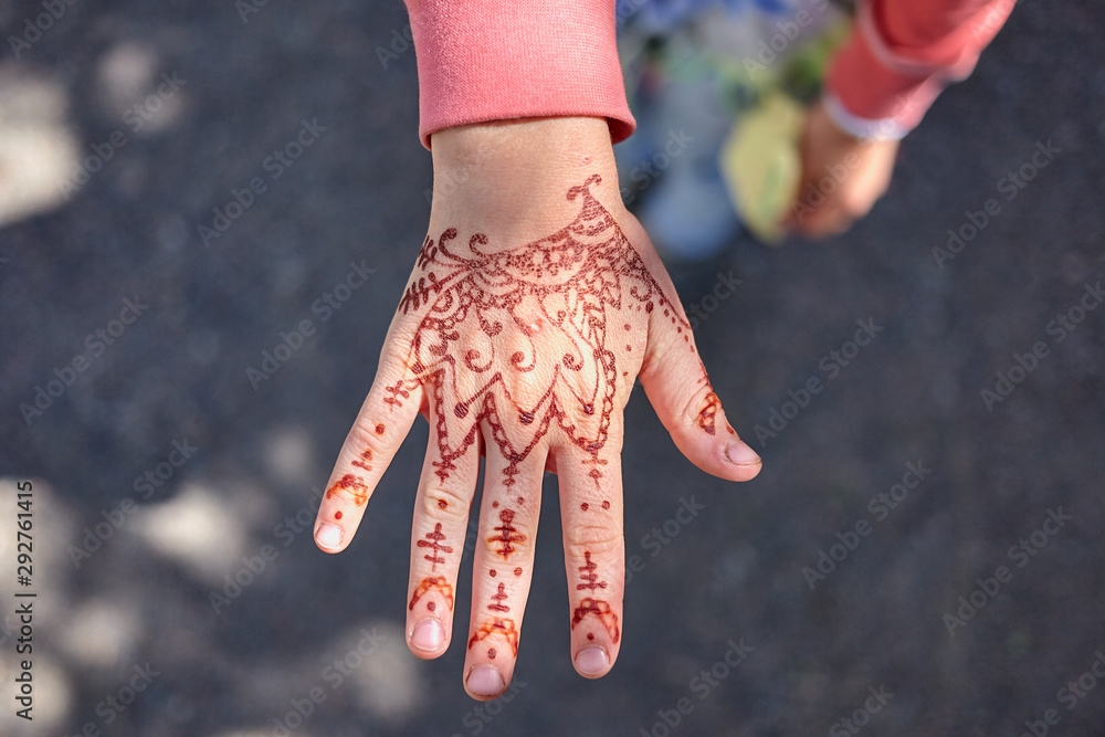 Child showing mehendi design of a dragon. Stock Photo | Adobe Stock