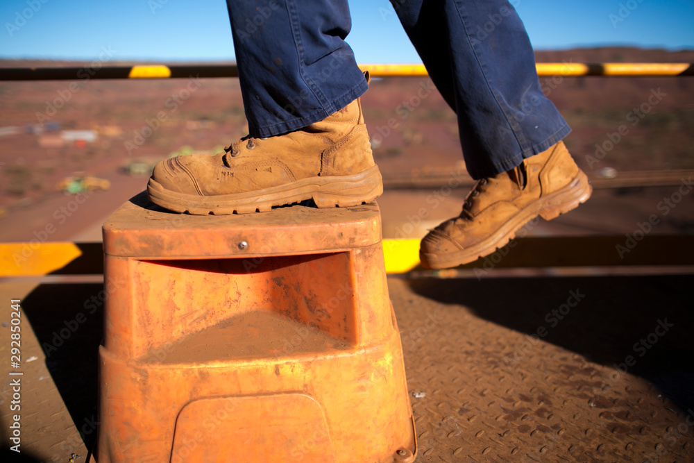 Miner worker wearing heavy duty steel cap boot using safety step white ...
