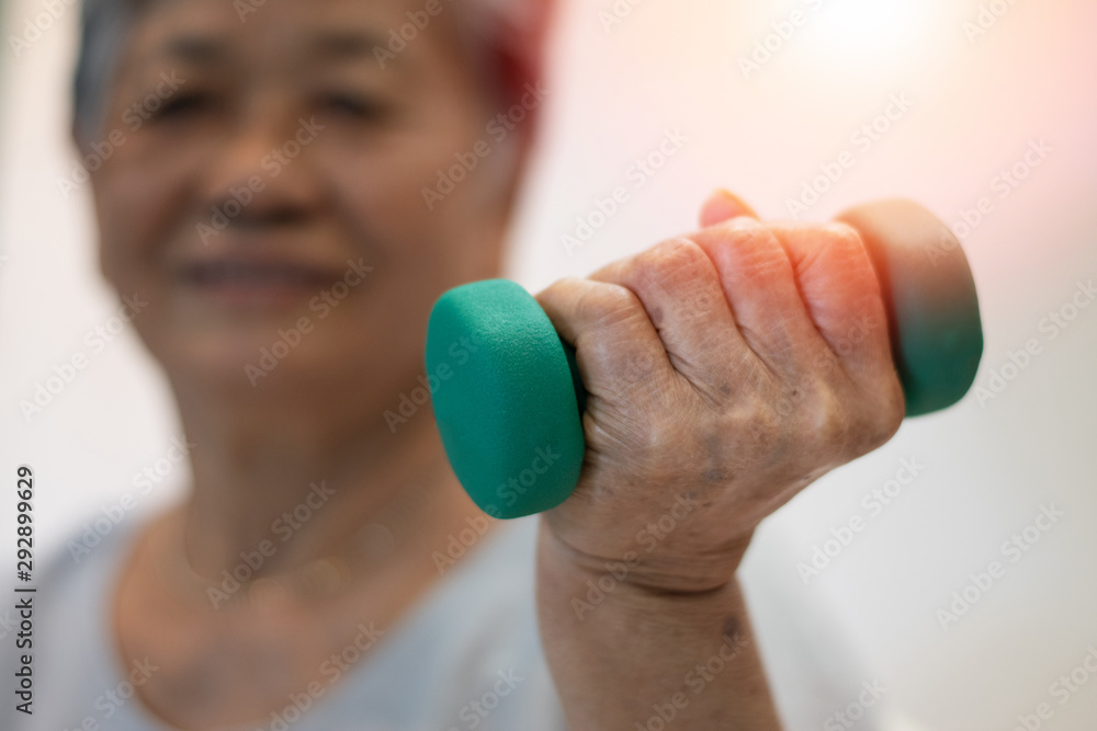 Senior elderly Asia woman hand holding dumbbell in physical therapy ...