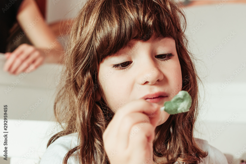 Close-up photo of little girl eating candy. Dental problems, teeth ...
