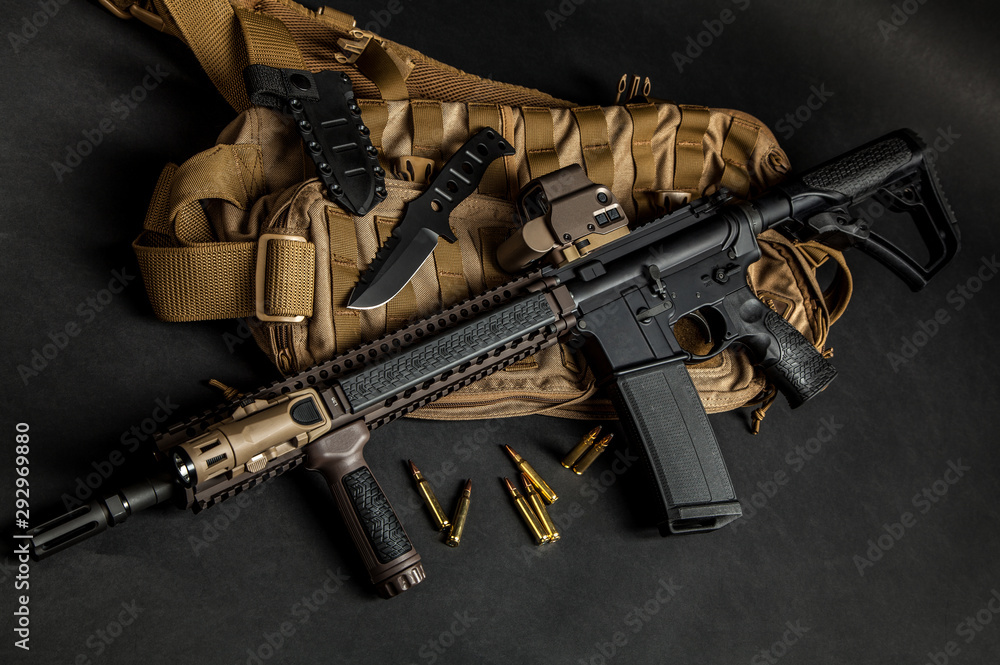 Modern automatic carbine with collimator sight on a dark background ...