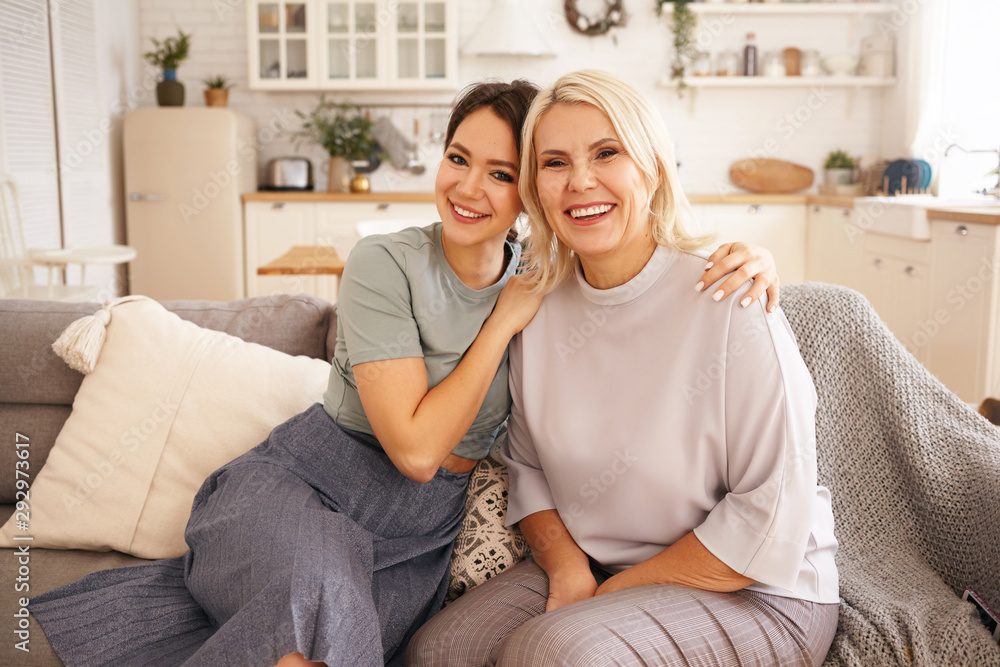 Sweet portrait of happy blonde middle aged mother in elegant clothes ...