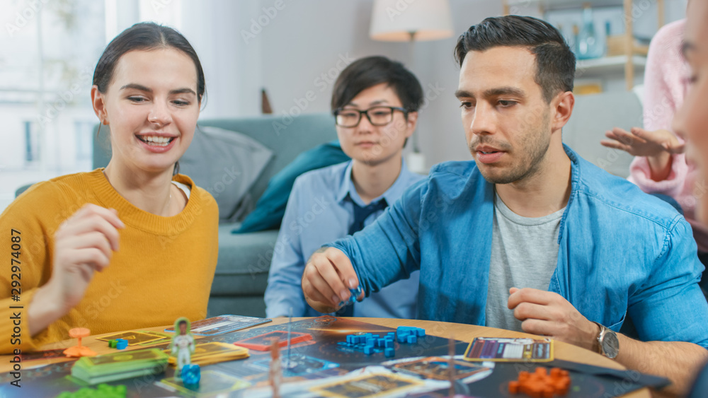 Diverse Group of Guys and Girls Playing in a Strategic Board Game with ...