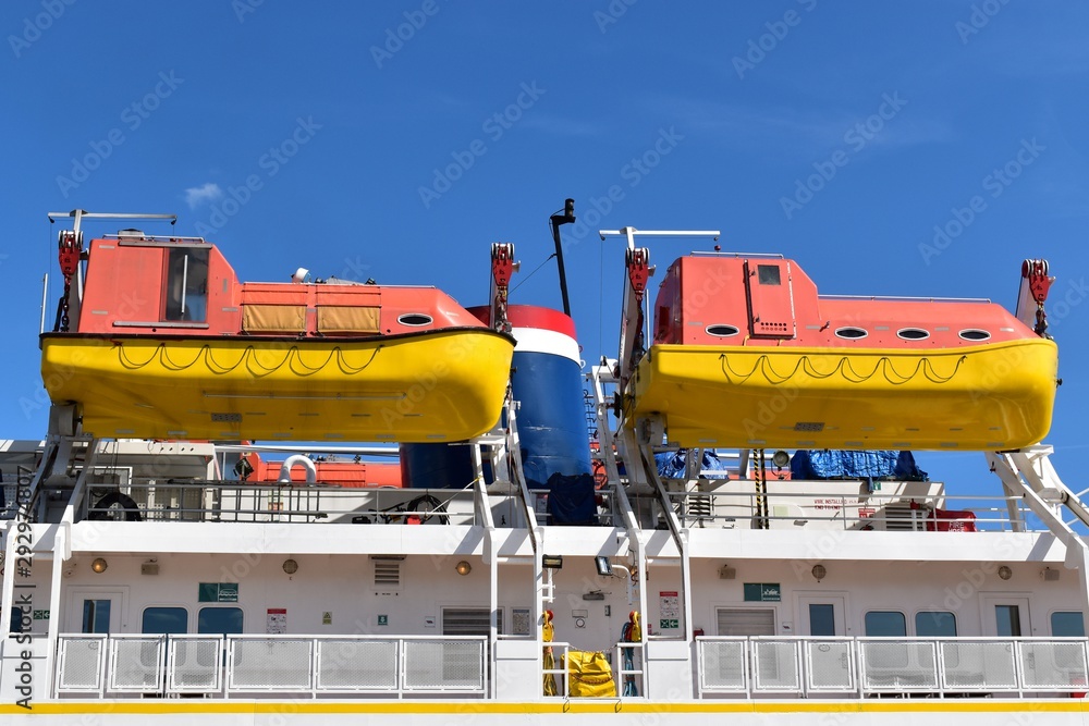 Picture of two colored rescue boats on board a cruise ship, mandatory ...