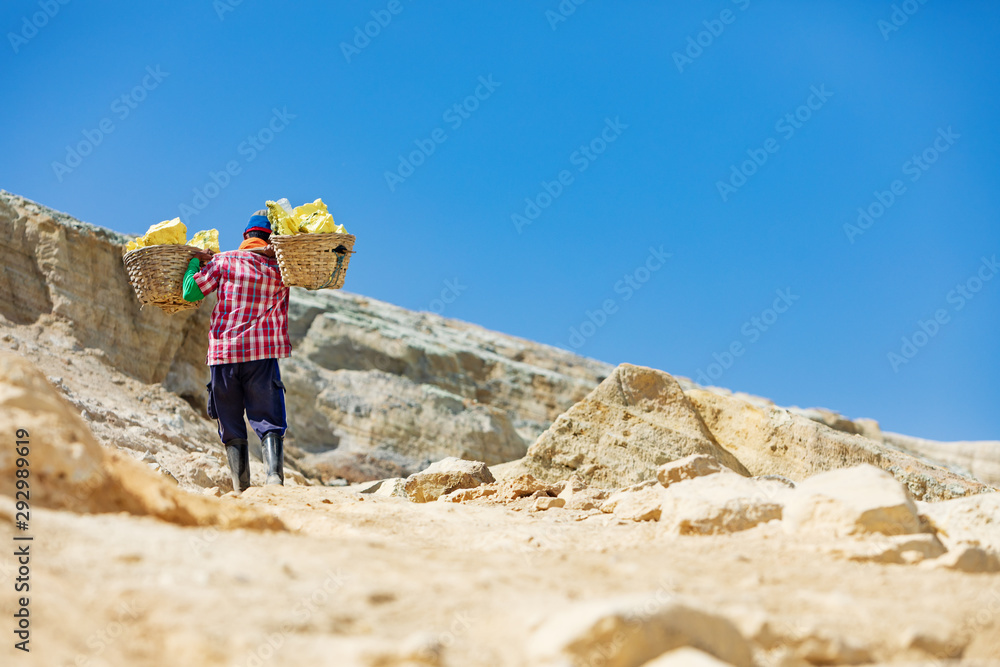 Heavy basket laden by pieces of natural sulfur carrying by miner from ...