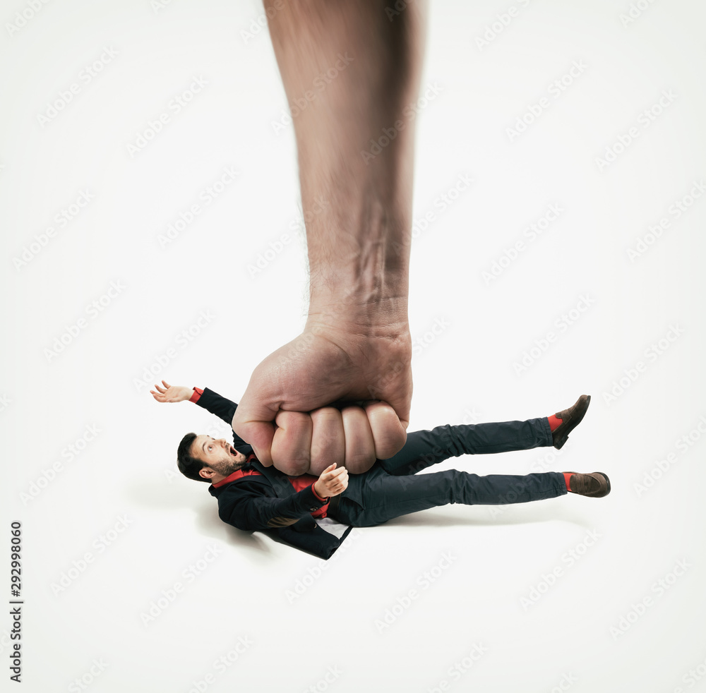 The big human fist bring down the man off his feet. Concept of ...