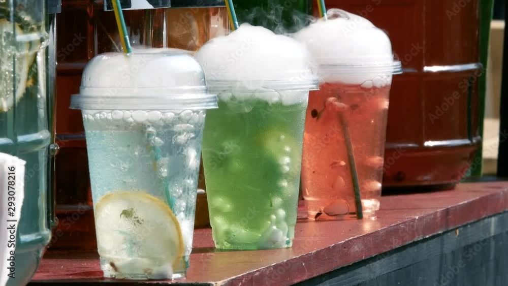 Coctails with smoke from liquid nitrogen inside plastic glasses. Non ...